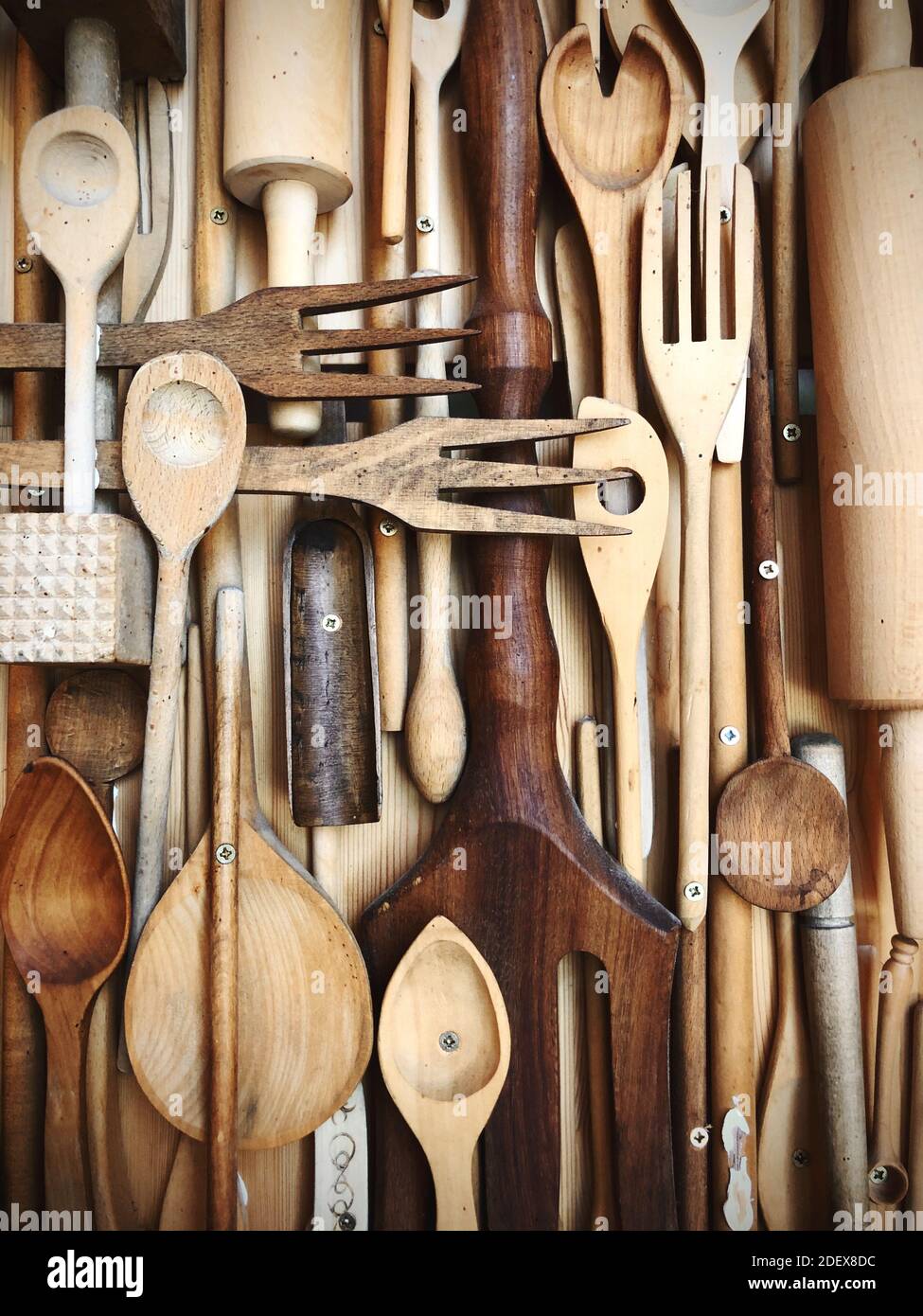Potpourri of old wooden cutlery as decoration on wall Stock Photo - Alamy