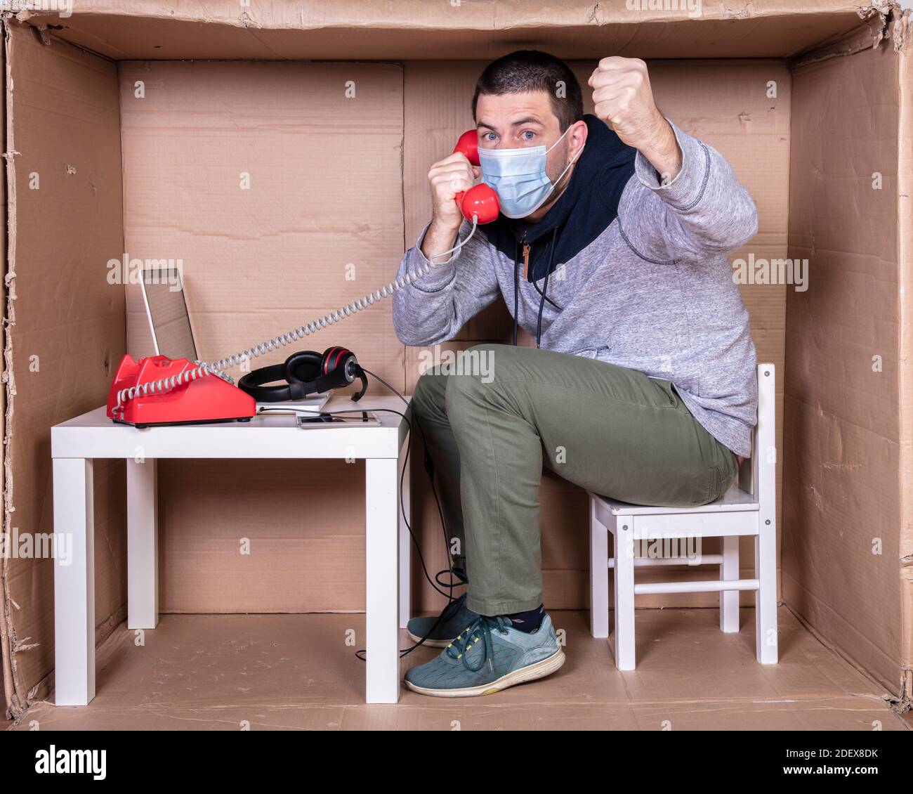 employee works from his own cardboard office to isolate himself from ...