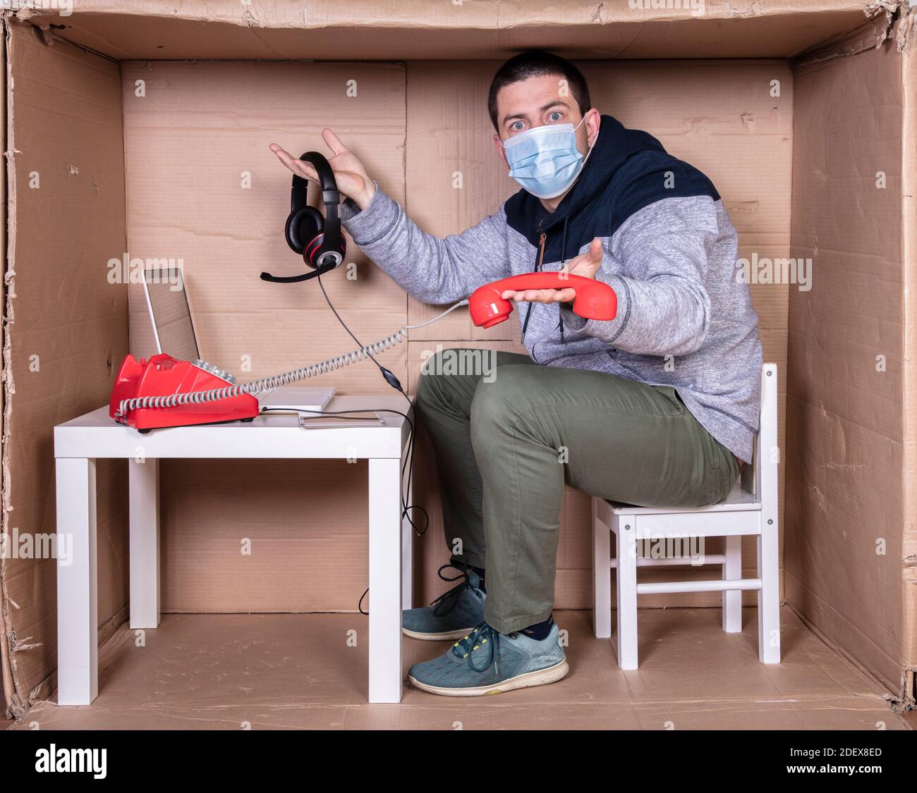 employee works from his own cardboard office to isolate himself from ...
