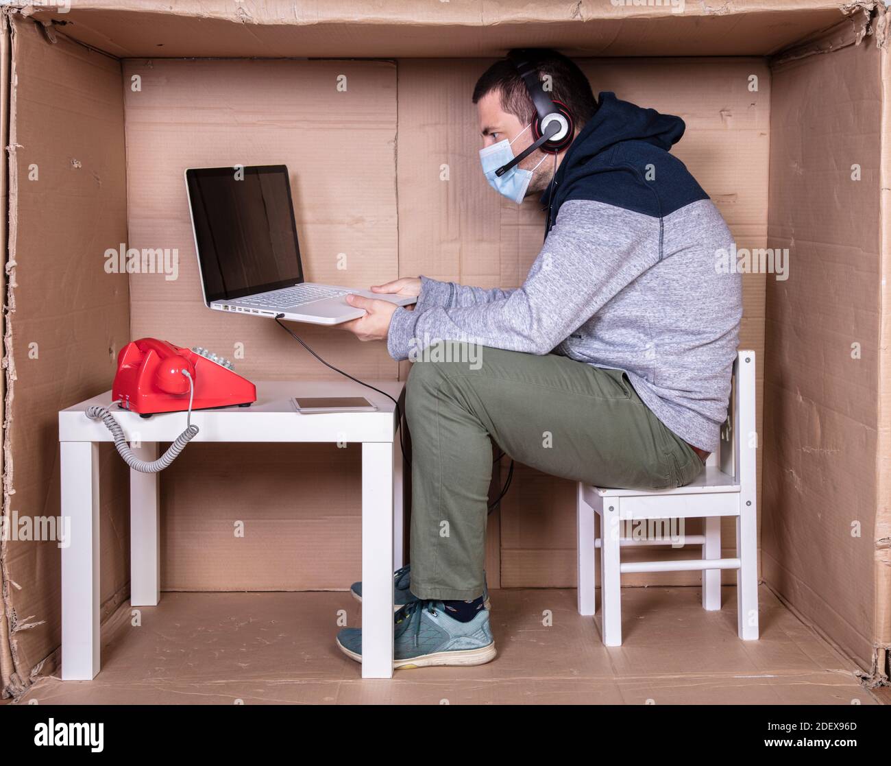 employee works from his own cardboard office to isolate himself from ...