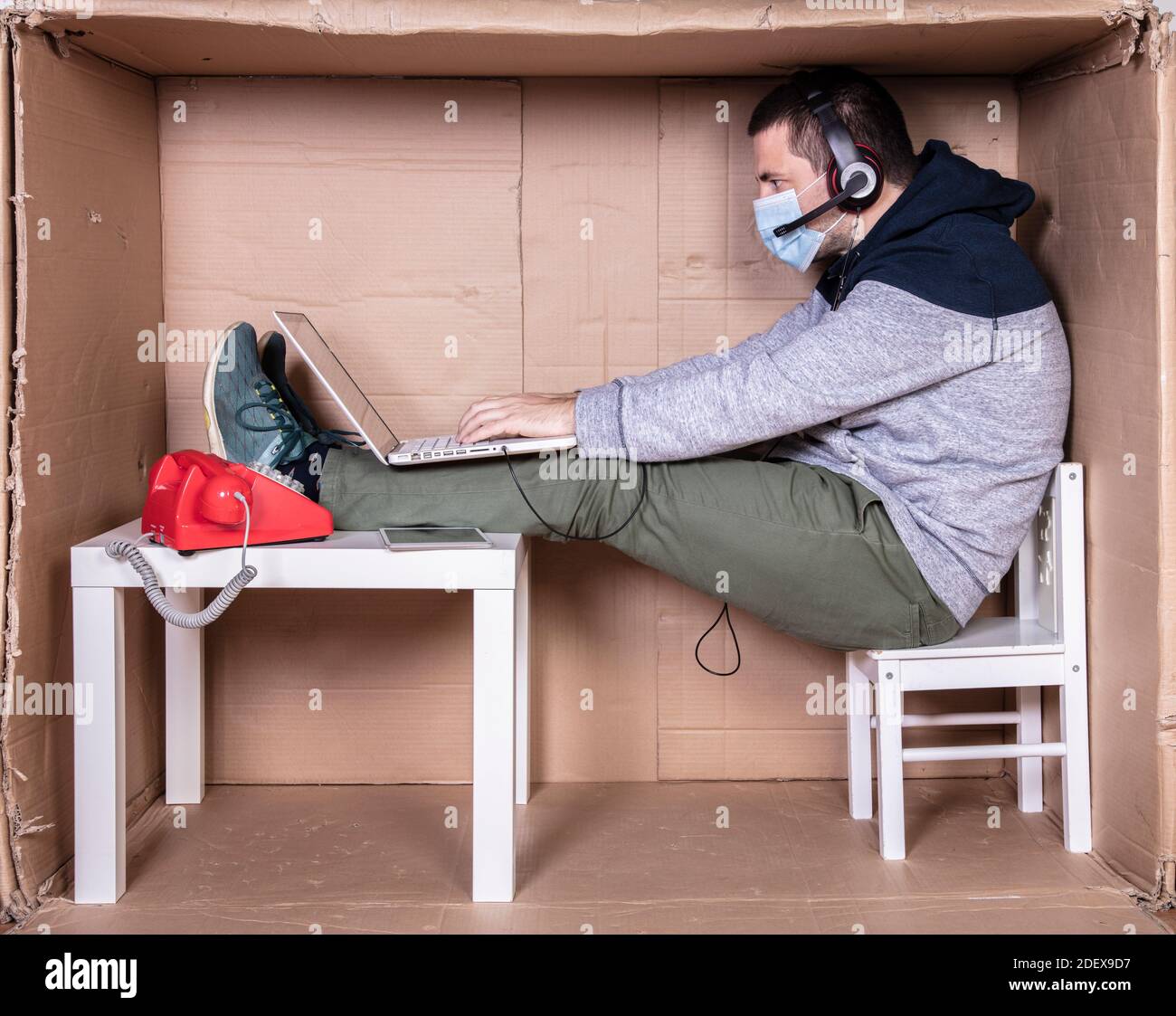 employee works from his own cardboard office to isolate himself from ...