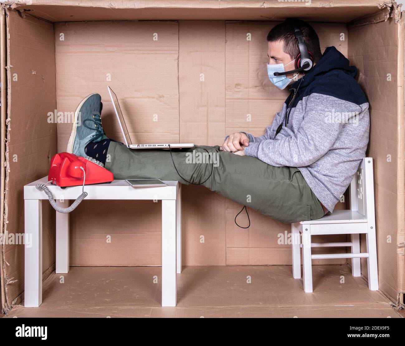 employee works from his own cardboard office to isolate himself from ...