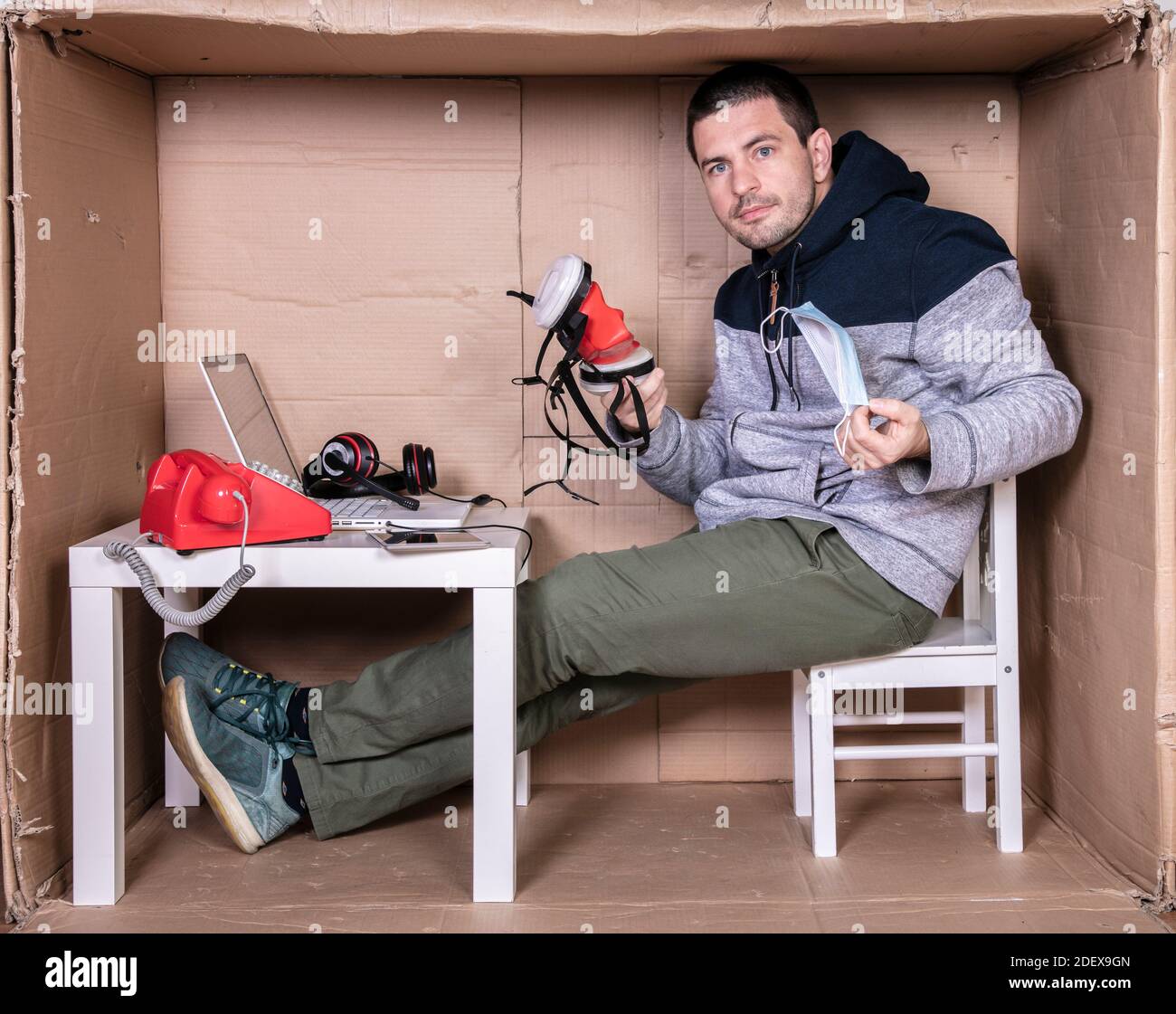 employee works from his own cardboard office to isolate himself from ...