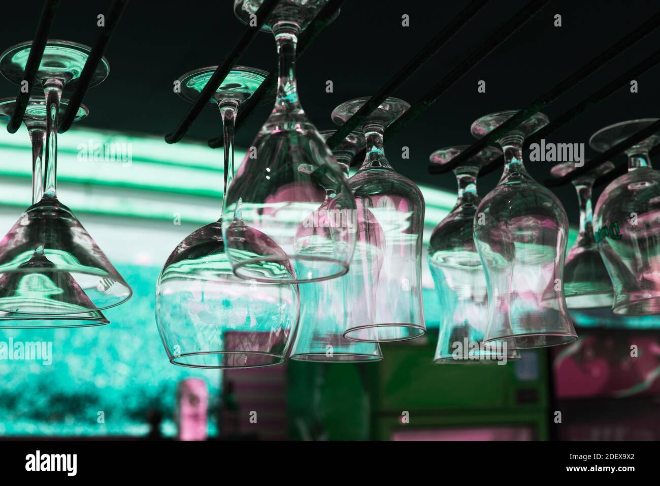 Wine glasses hang over the bar Stock Photo - Alamy