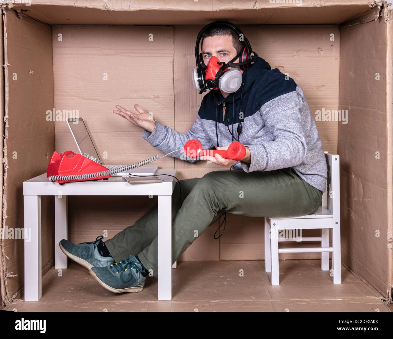 employee works from his own cardboard office to isolate himself from ...