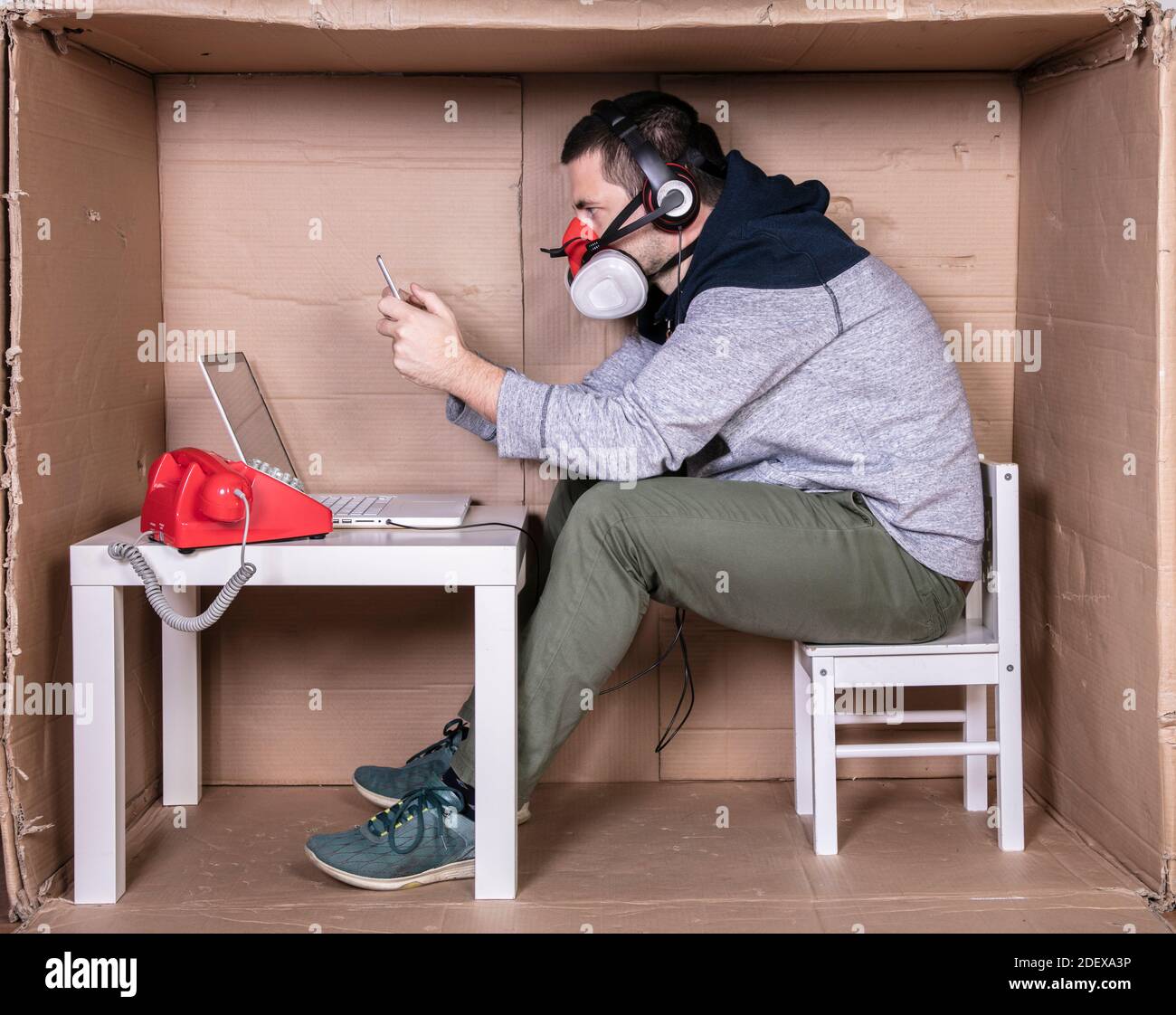 employee works from his own cardboard office to isolate himself from ...
