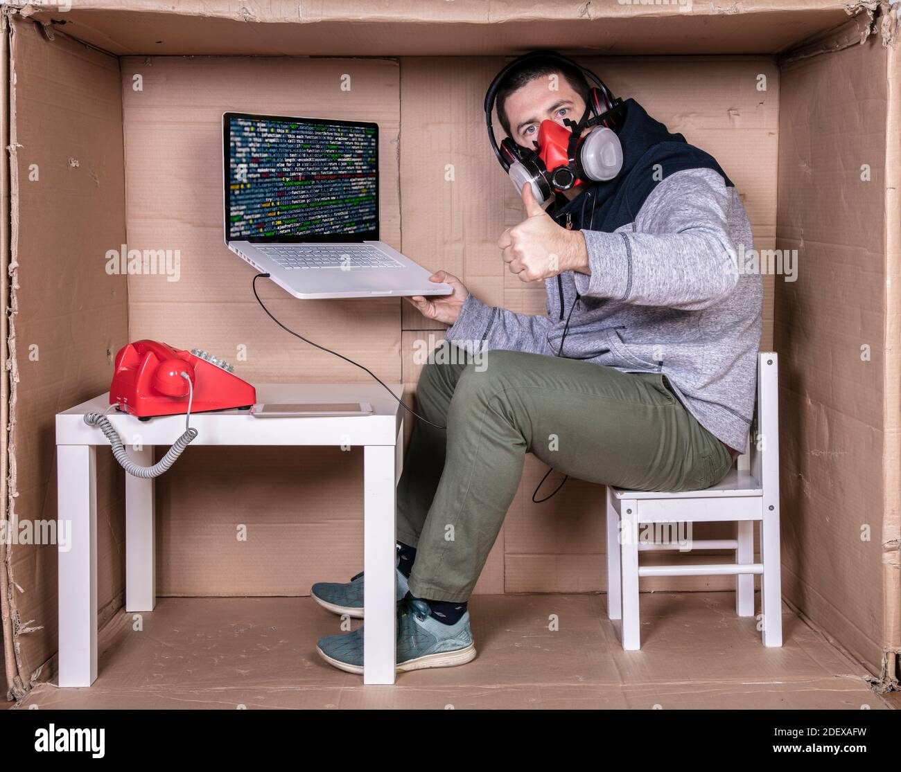 employee works from his own cardboard office to isolate himself from ...