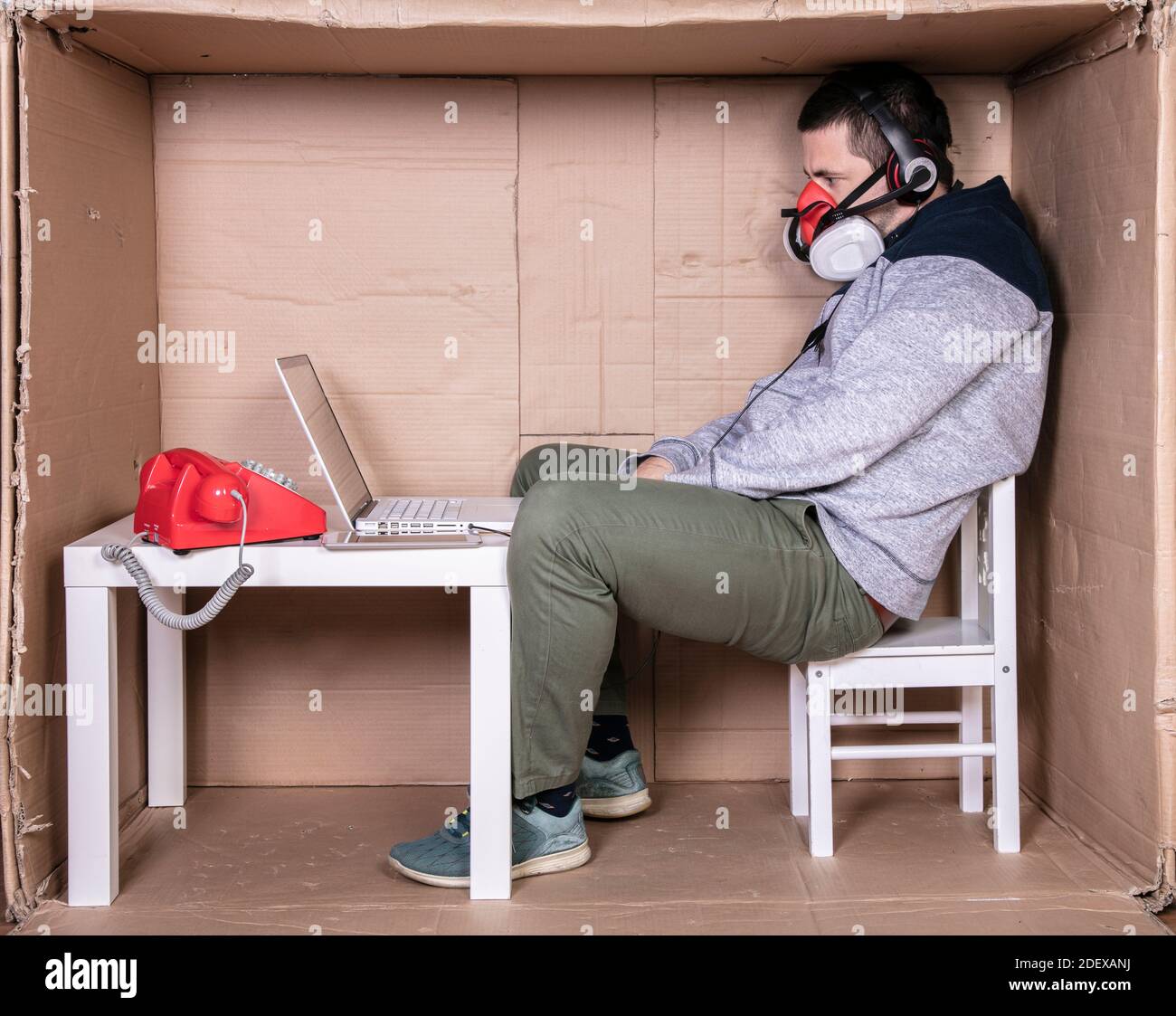 employee works from his own cardboard office to isolate himself from ...