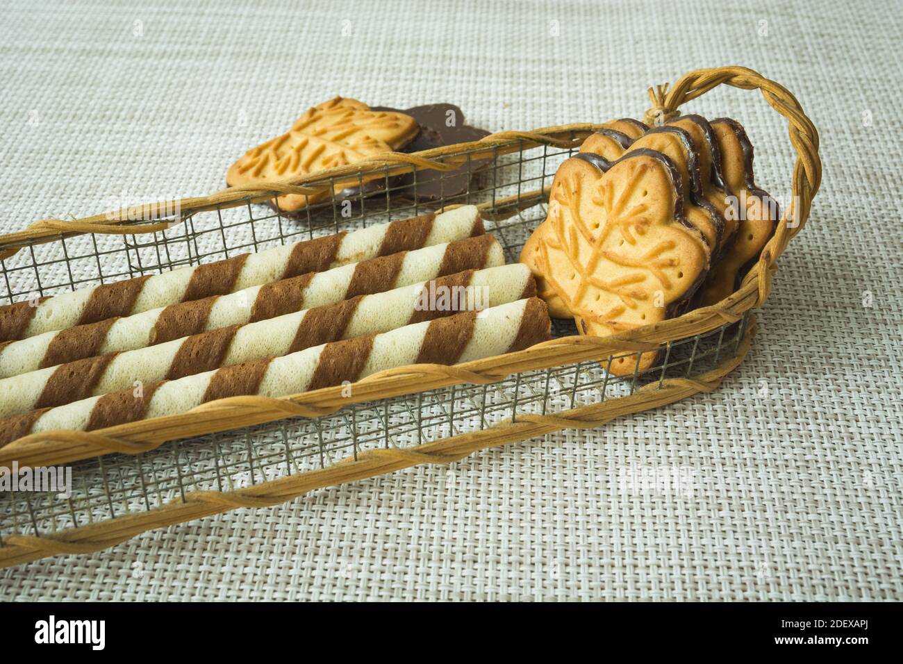 Tubes with cream and cakes in the basket, closeup Stock Photo - Alamy