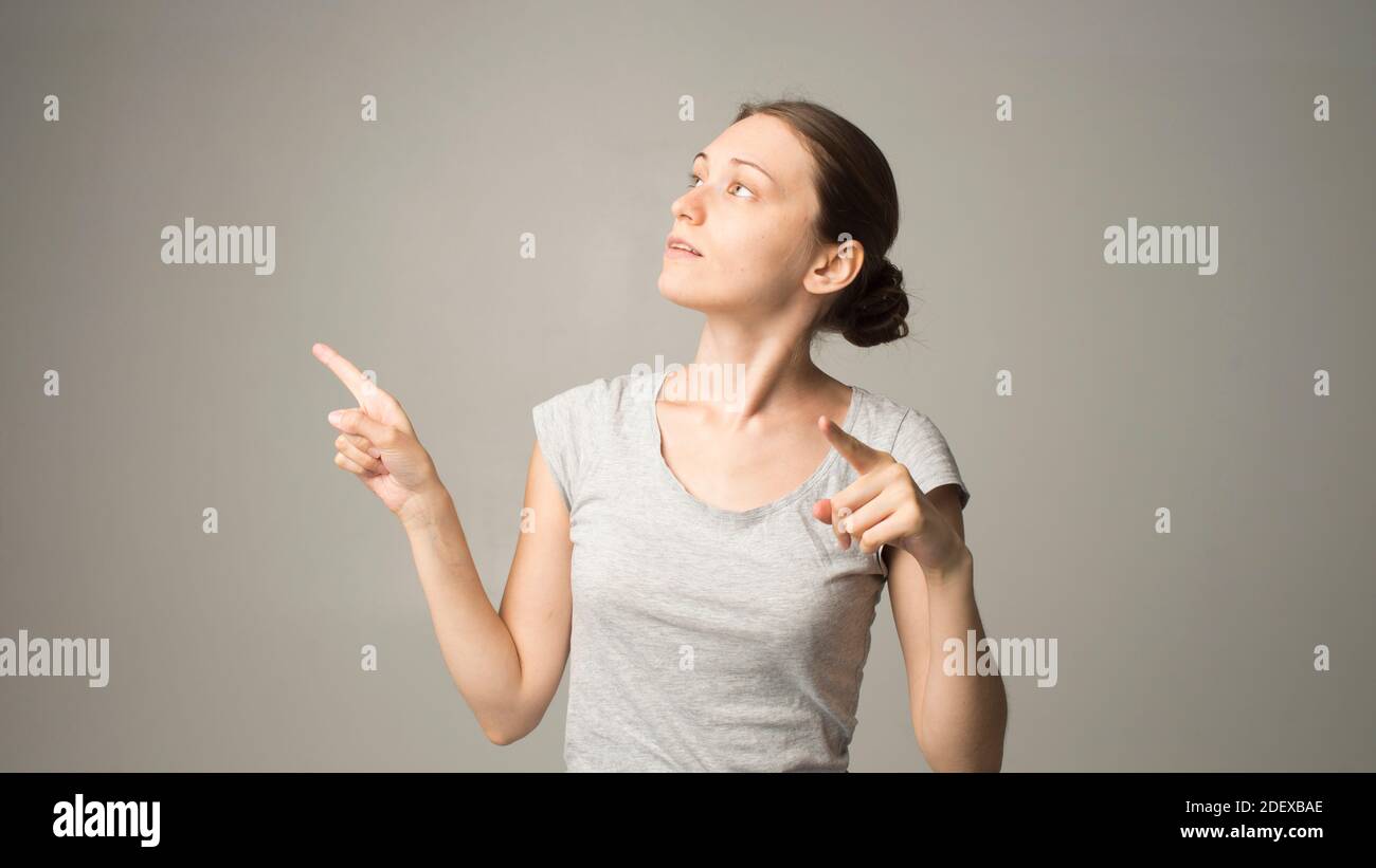 young woman shows something Stock Photo - Alamy