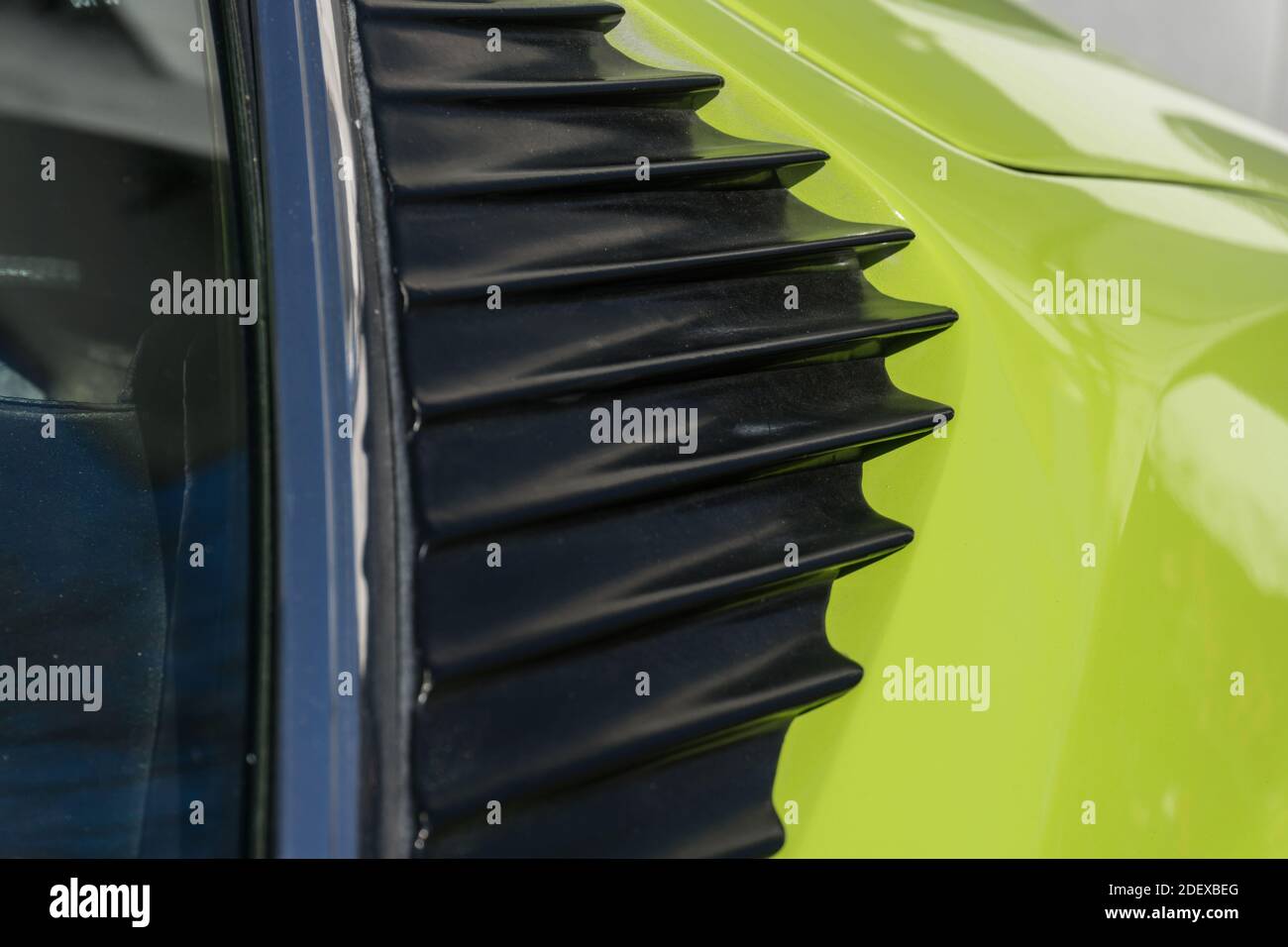 Close up of the side bodywork and windows of a lime green De Tomaso ...