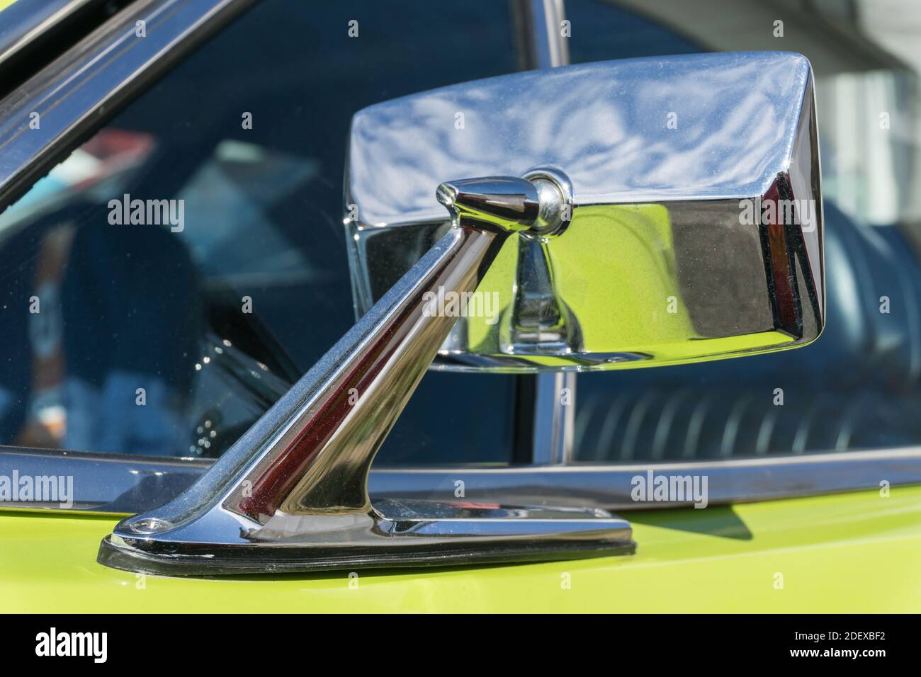 Close up of the chrome door mirror on a lime green De Tomaso Pantera ...