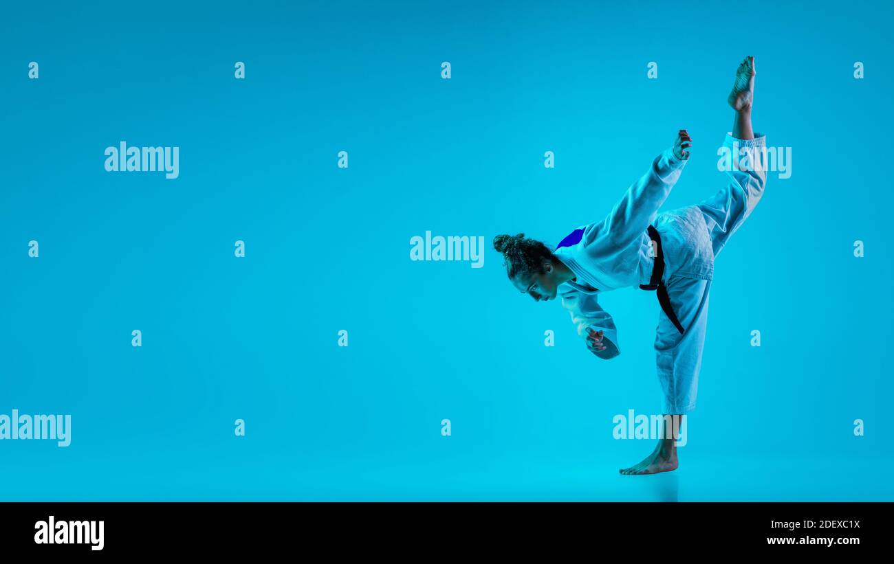 Concentration. Professional female judoist in white judo kimono ...
