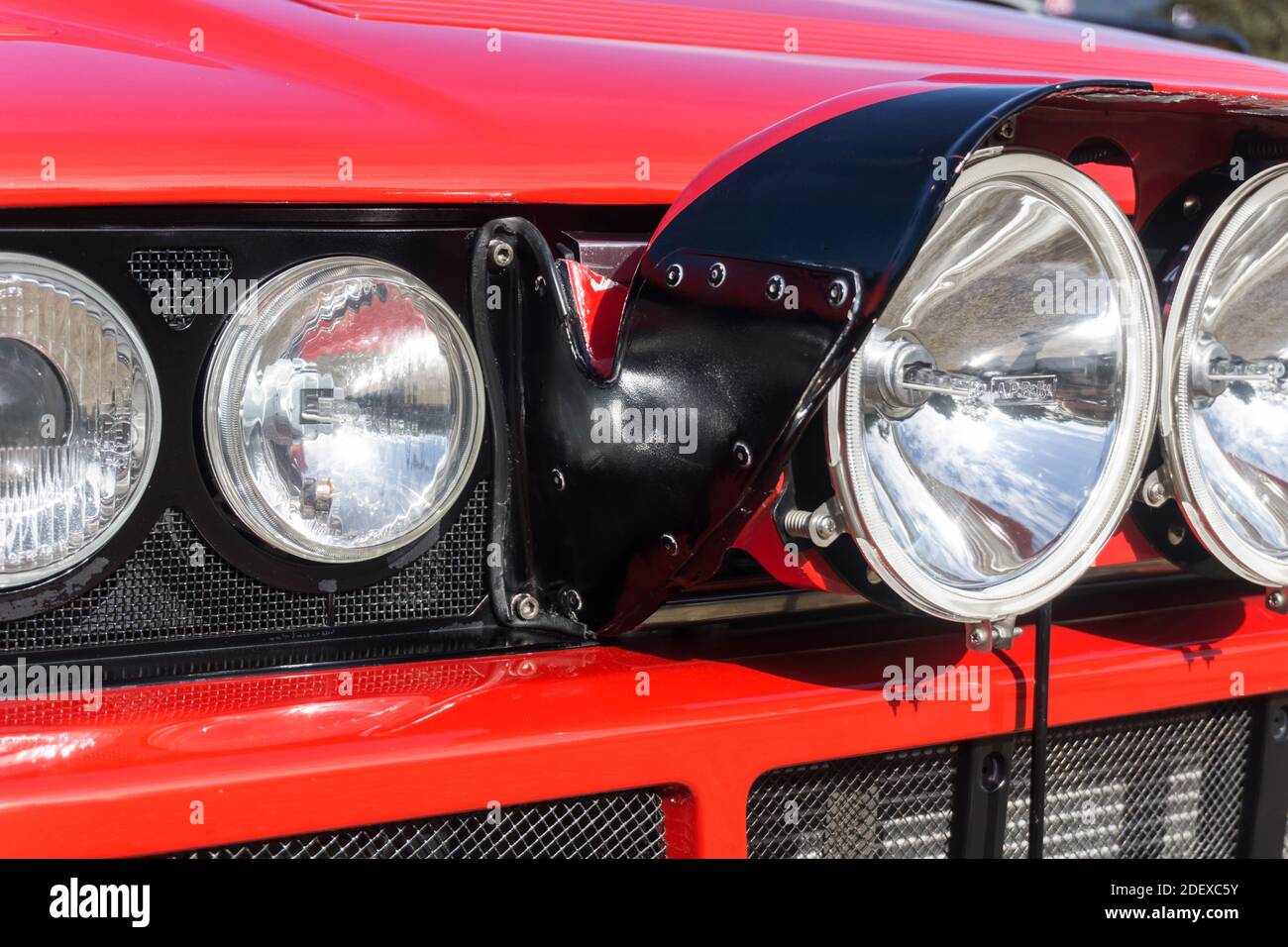 Close up detail of the headlights and rally light pod on a red a Lancia ...