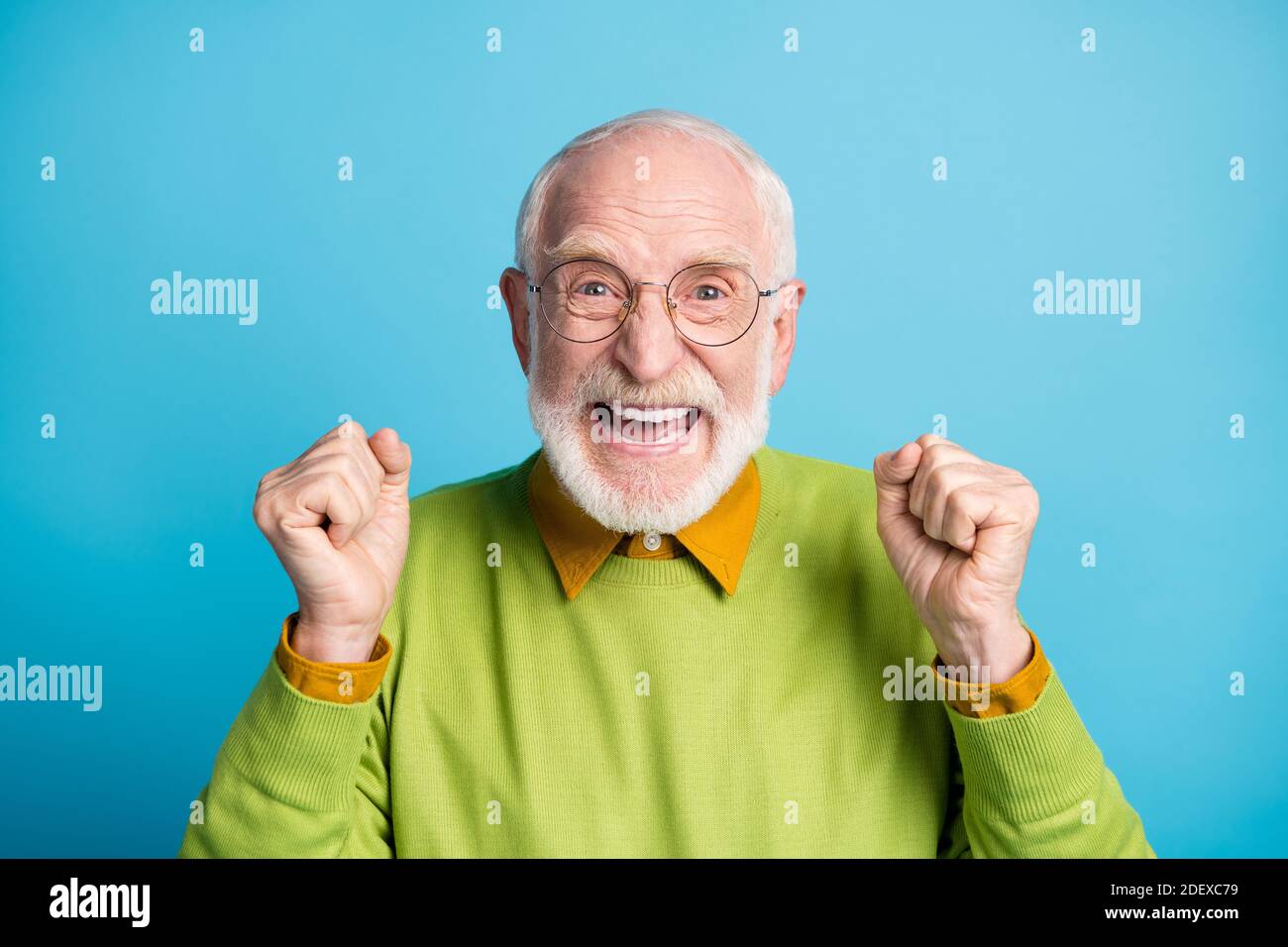 Photo of crazy retired old man open mouth raise fists wear specs green ...