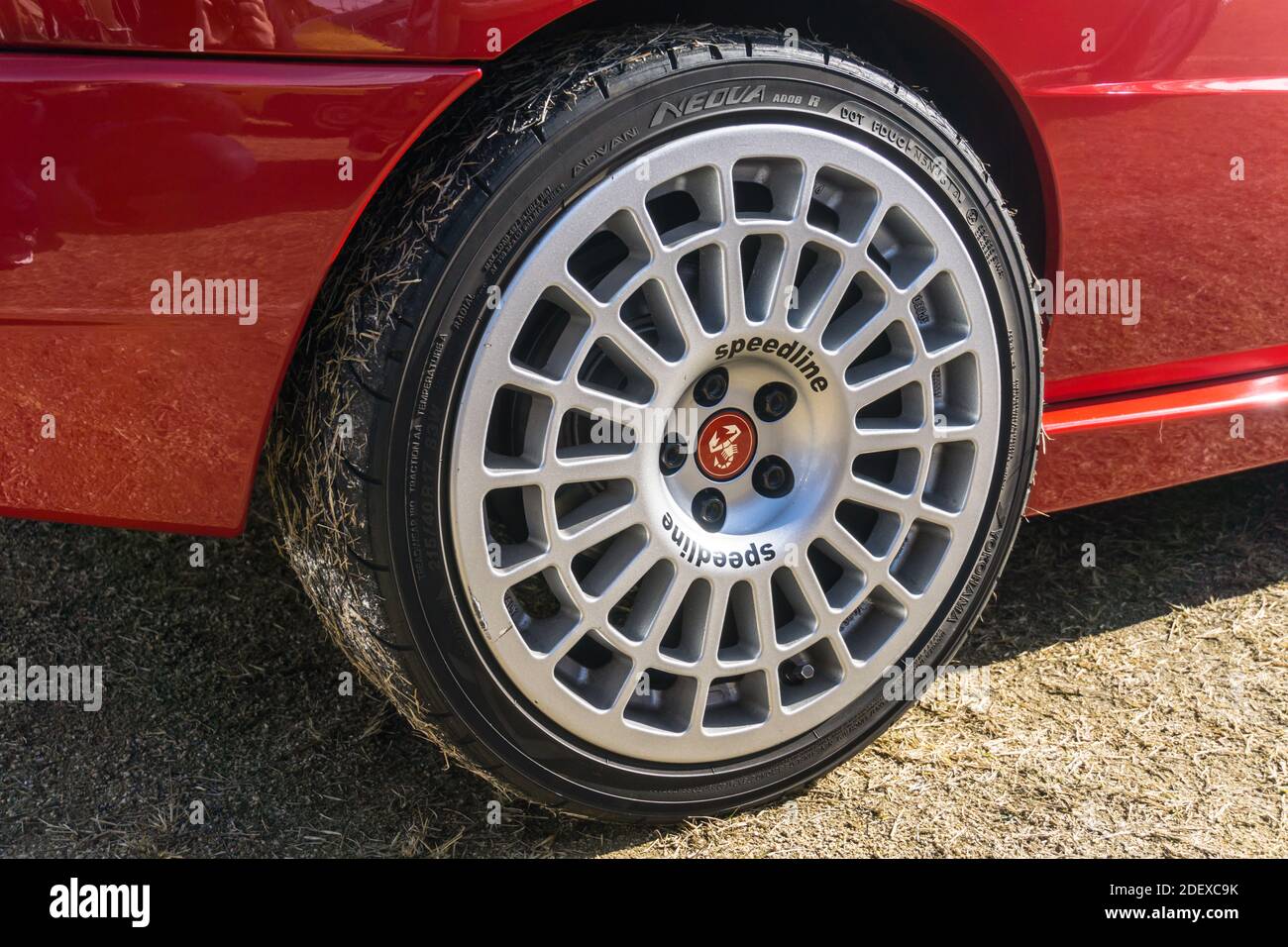 Close up of silver five-bolt Speedline Montecarlo alloy wheels on a red ...