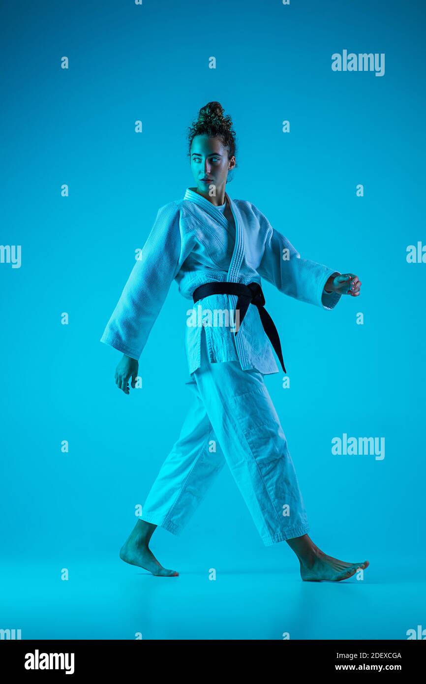 Walking. Professional female judoist in white judo kimono practicing ...