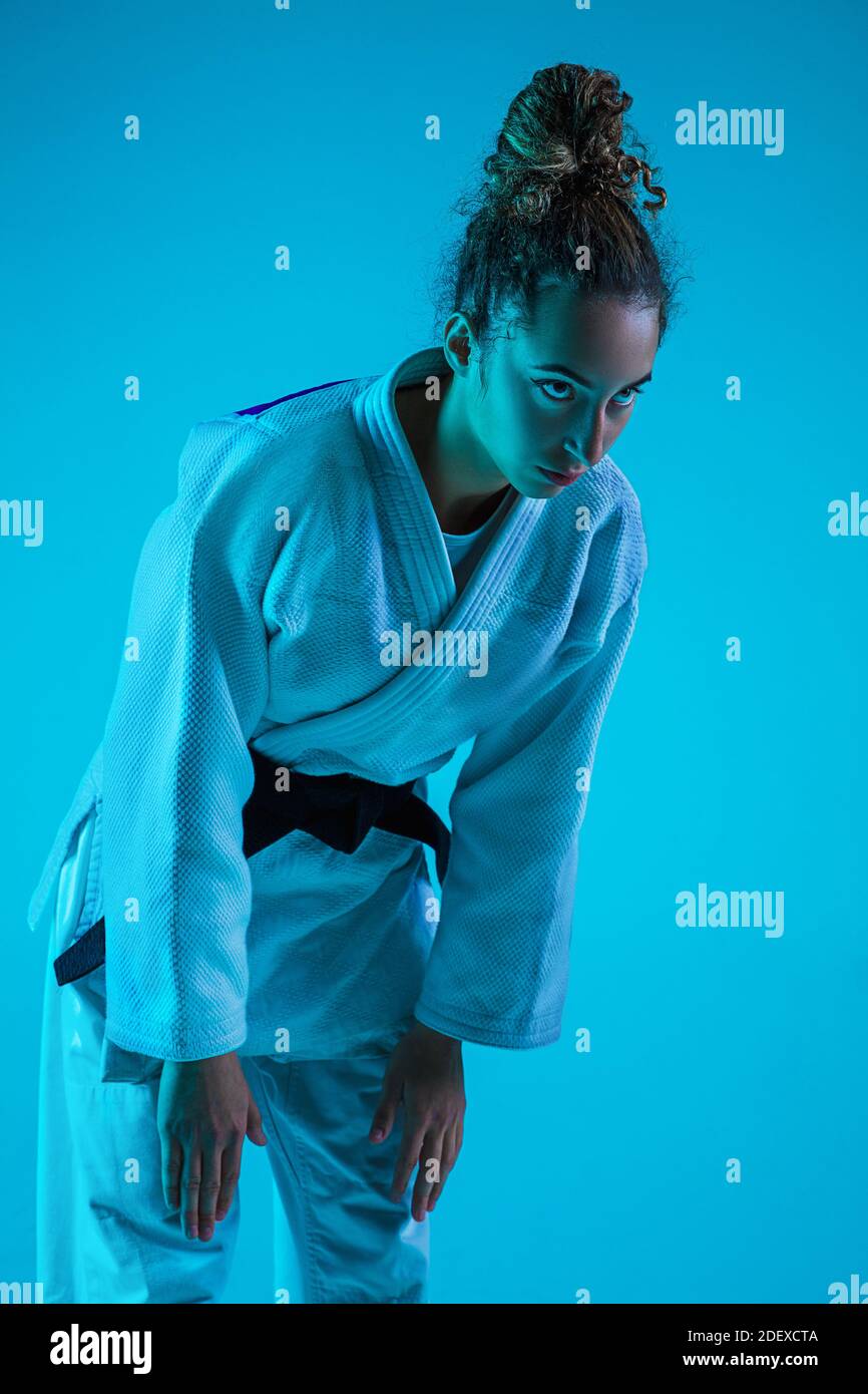 Tachi-rei. Professional female judoist in white judo kimono practicing ...