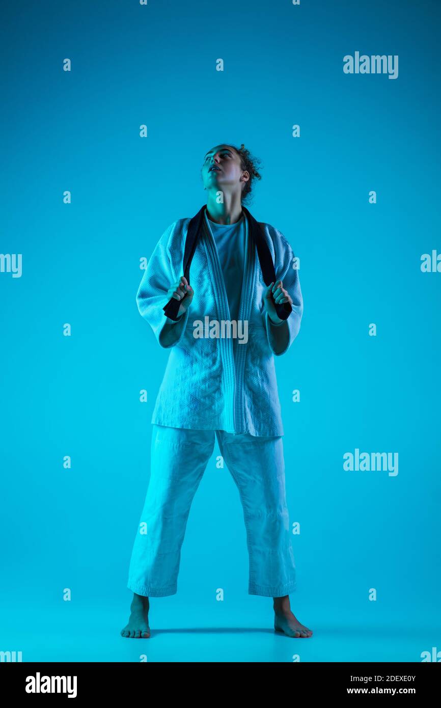 Take a rest. Professional female judoist in white judo kimono ...