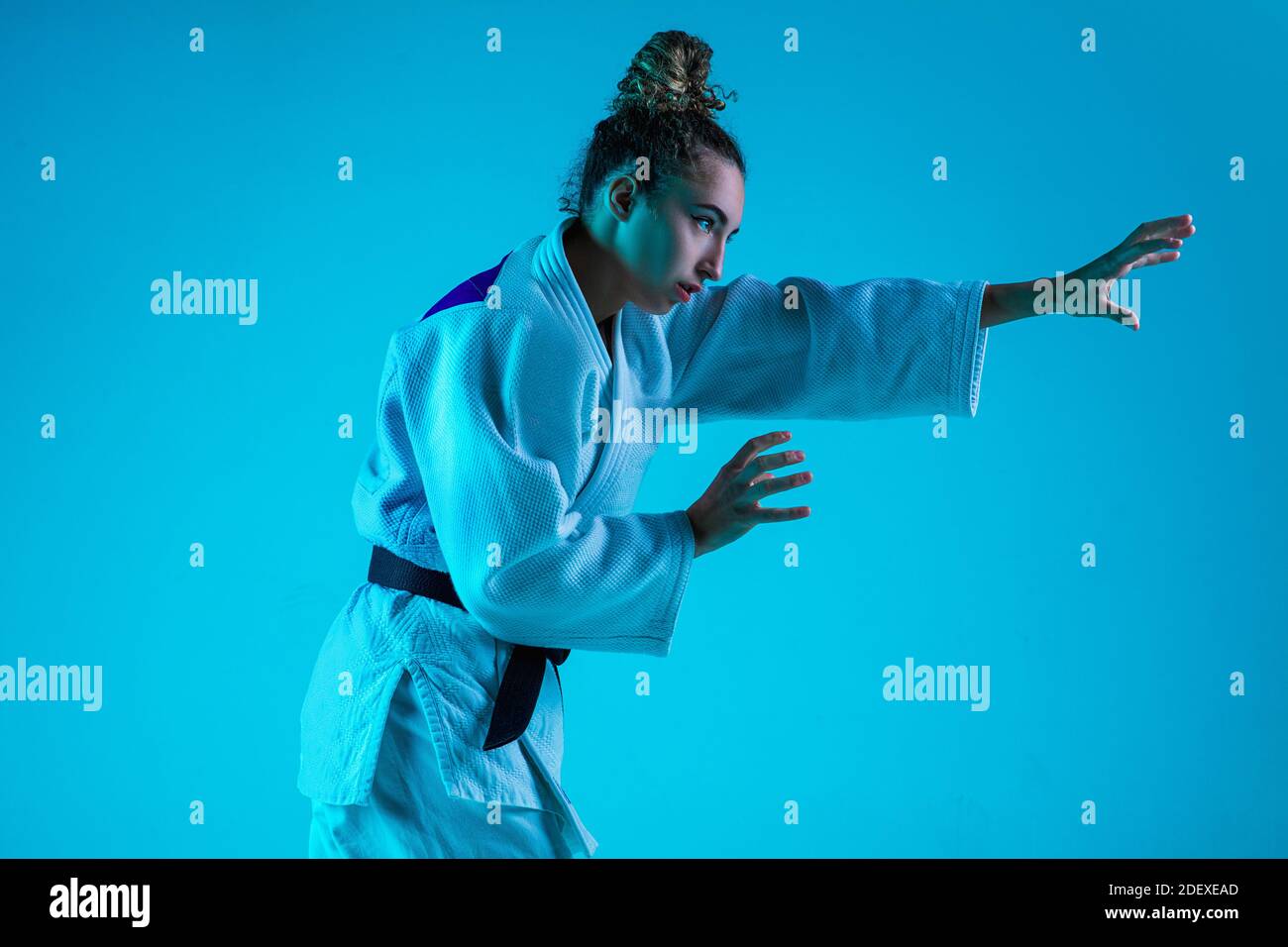 View from side. Professional female judoist in white judo kimono ...