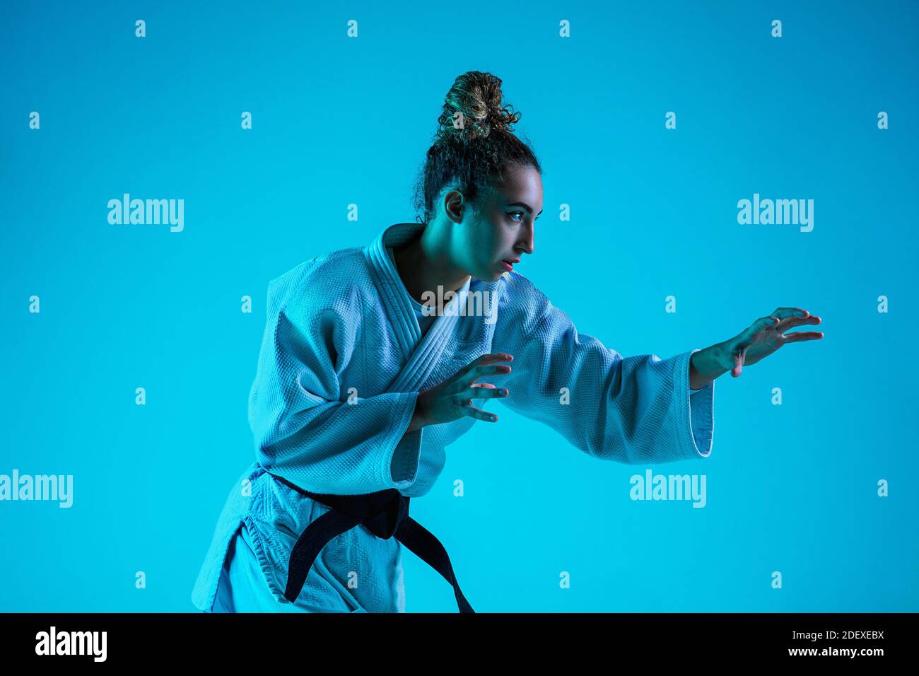View from side. Professional female judoist in white judo kimono ...