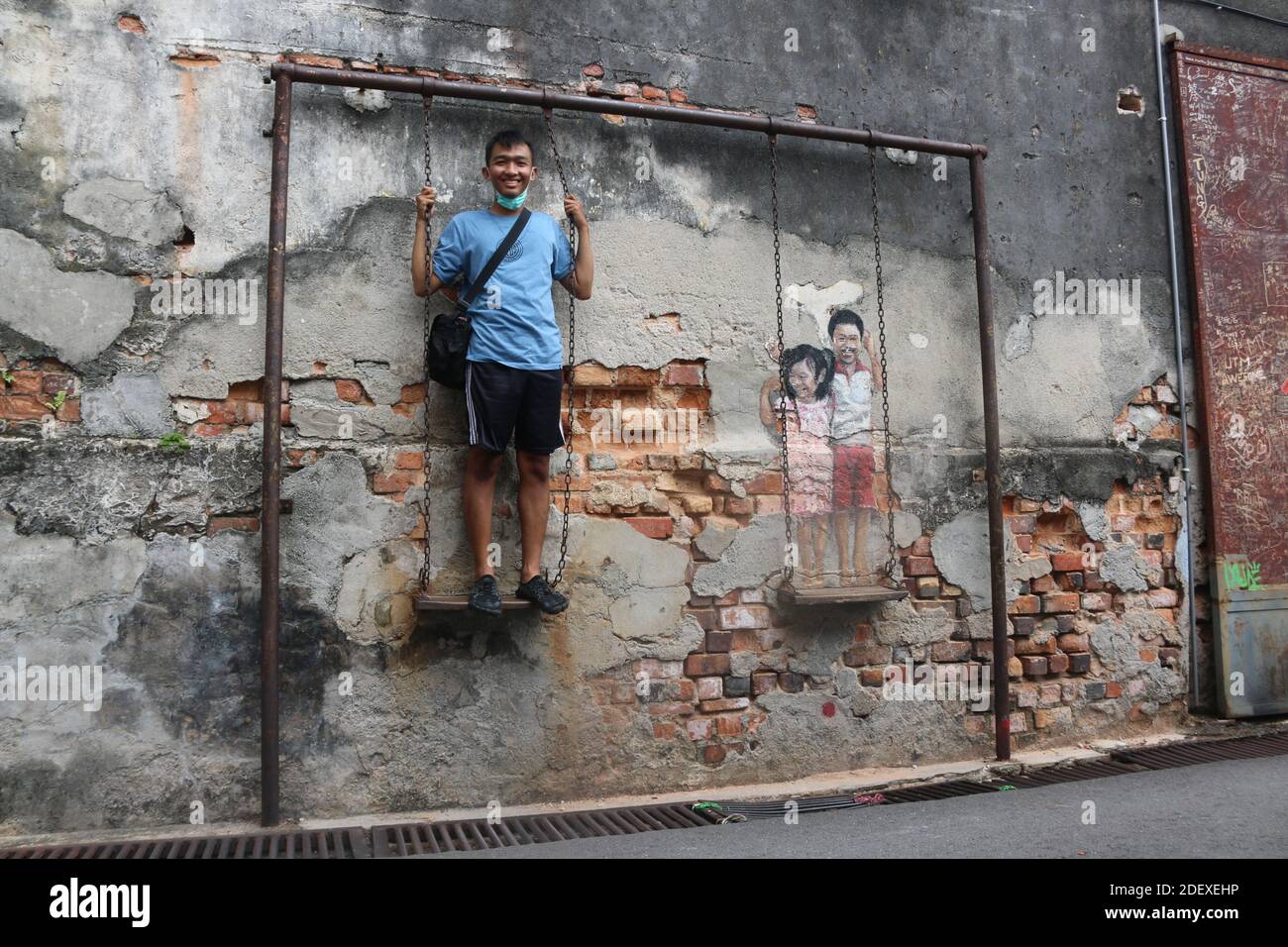 GEORGET, MALAYSIA - Nov 28, 2020: Asian man standing.Street art ´Boy ...