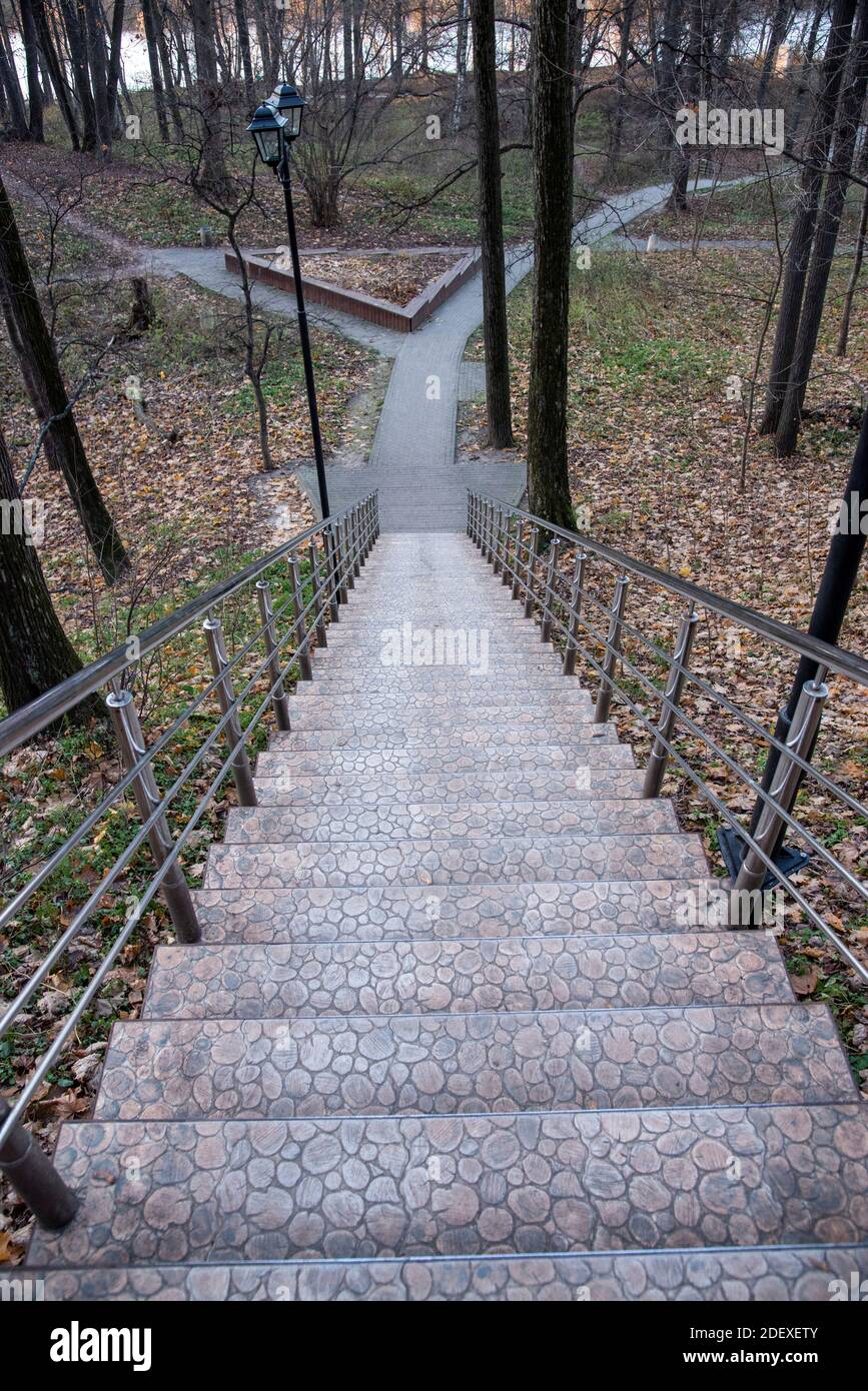 Long stone staircase with metal railing in autumn Park, top view Stock ...