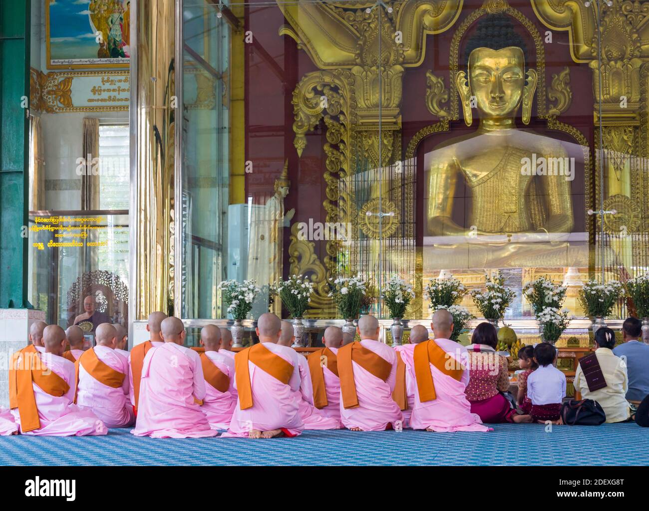 Buddhist nuns praying inside temple pagoda at Thetkya Thidar Nunnery ...