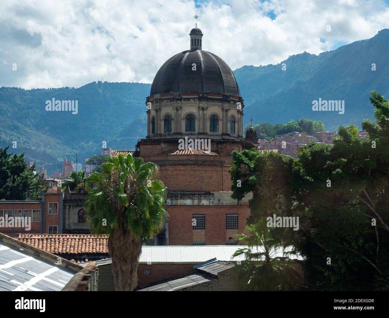 Cathedral Roof Top Surrounded by Trees with Green Mountains in the ...
