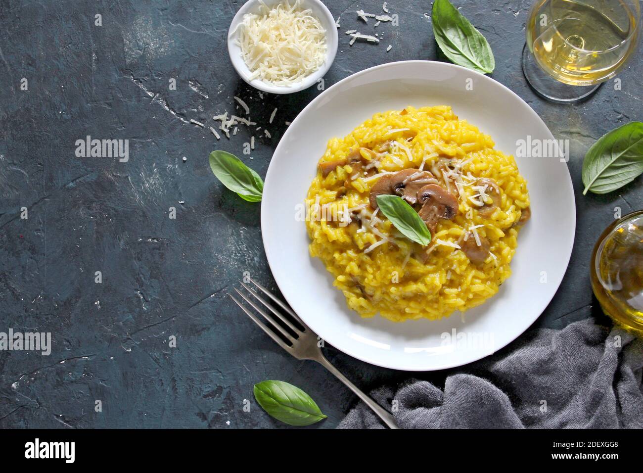 Italian risotto with mushrooms, saffron and parmesan cheese on dark ...