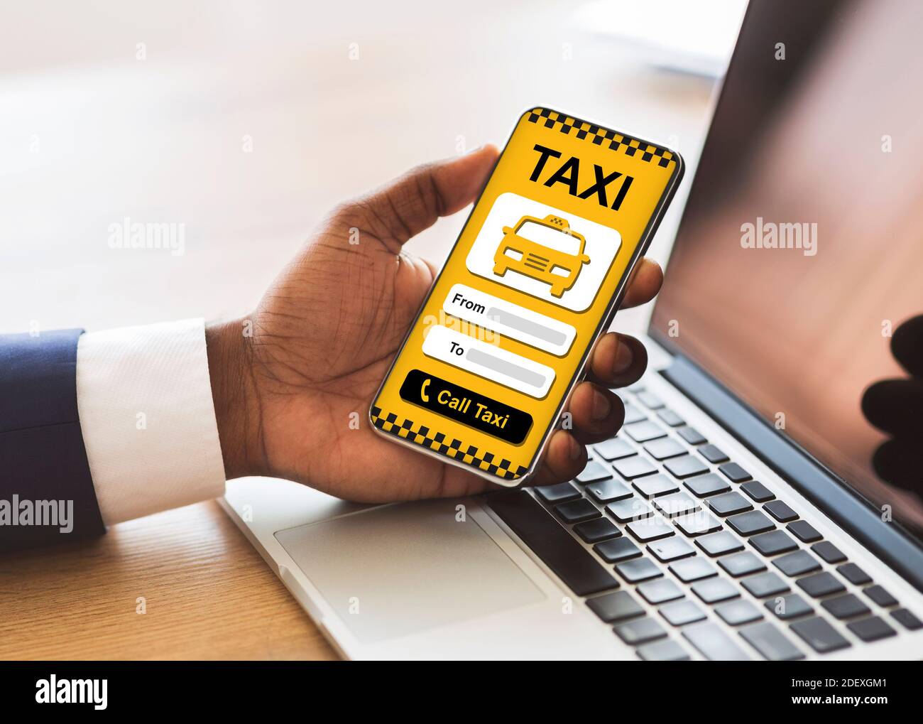 Black businessman holding cellphone with taxi app interface Stock Photo ...