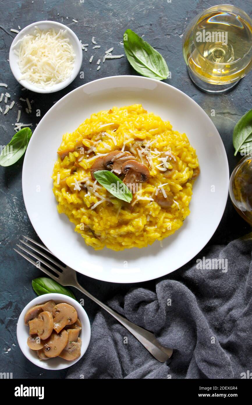 Italian risotto with mushrooms, saffron and parmesan cheese on dark ...