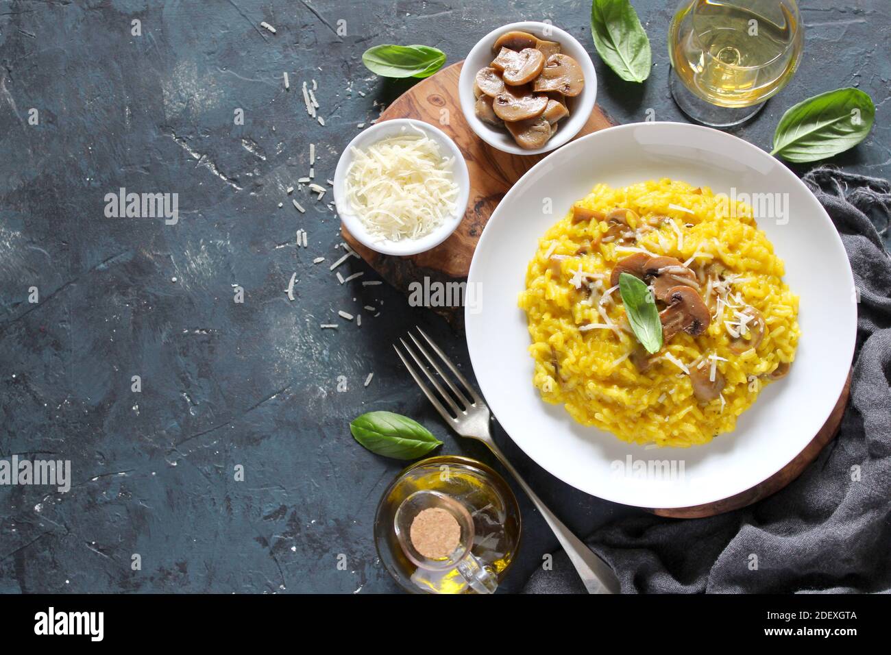 Italian risotto with mushrooms, saffron and parmesan cheese on dark ...