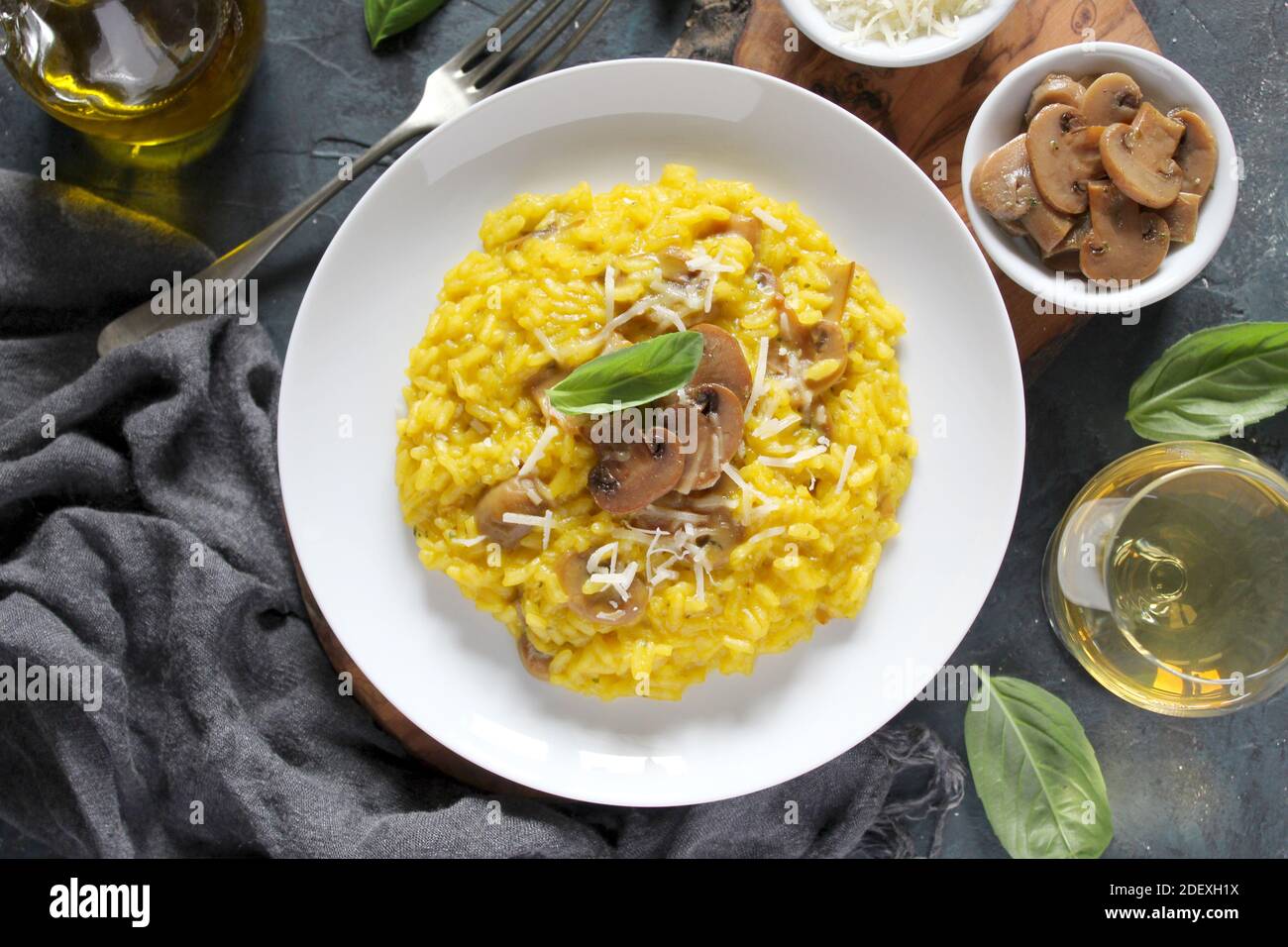 Italian risotto with mushrooms, saffron and parmesan cheese on dark ...