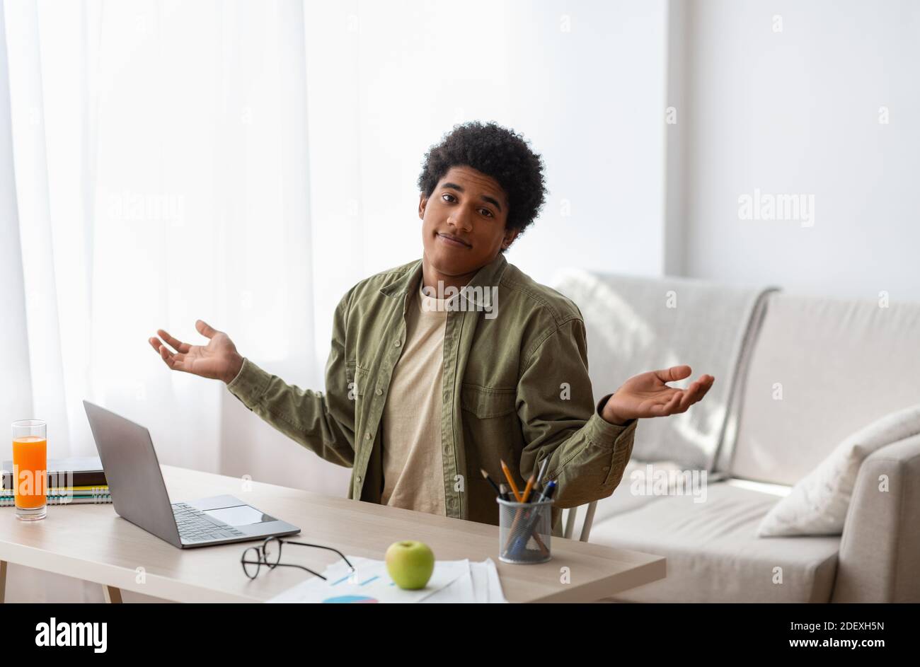 Puzzled black student sitting in front of laptop, not understanding ...