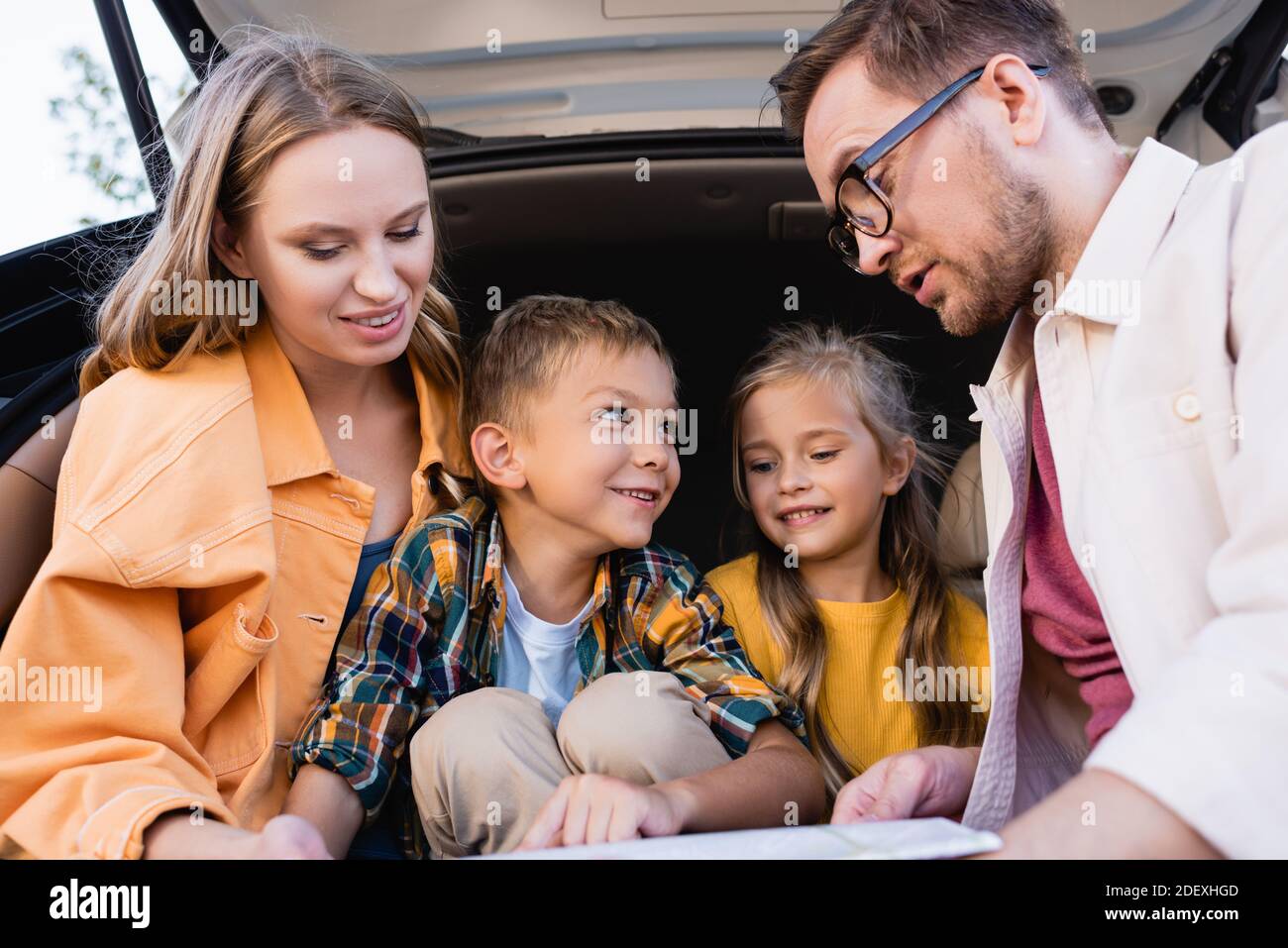 Happy family with travel map hi-res stock photography and images - Alamy