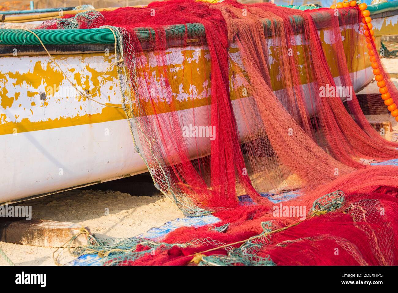 Fishing nets hanging over fishing boat hi-res stock photography and ...