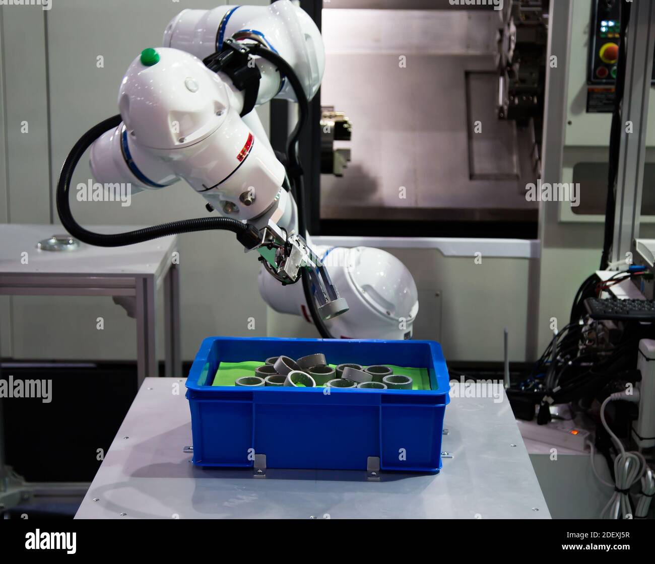 Automated process industrial robot loading metal part to CNC machine ...