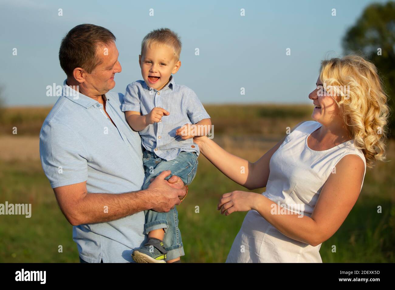 Happy mom dad and little son in nature. Family Stock Photo - Alamy