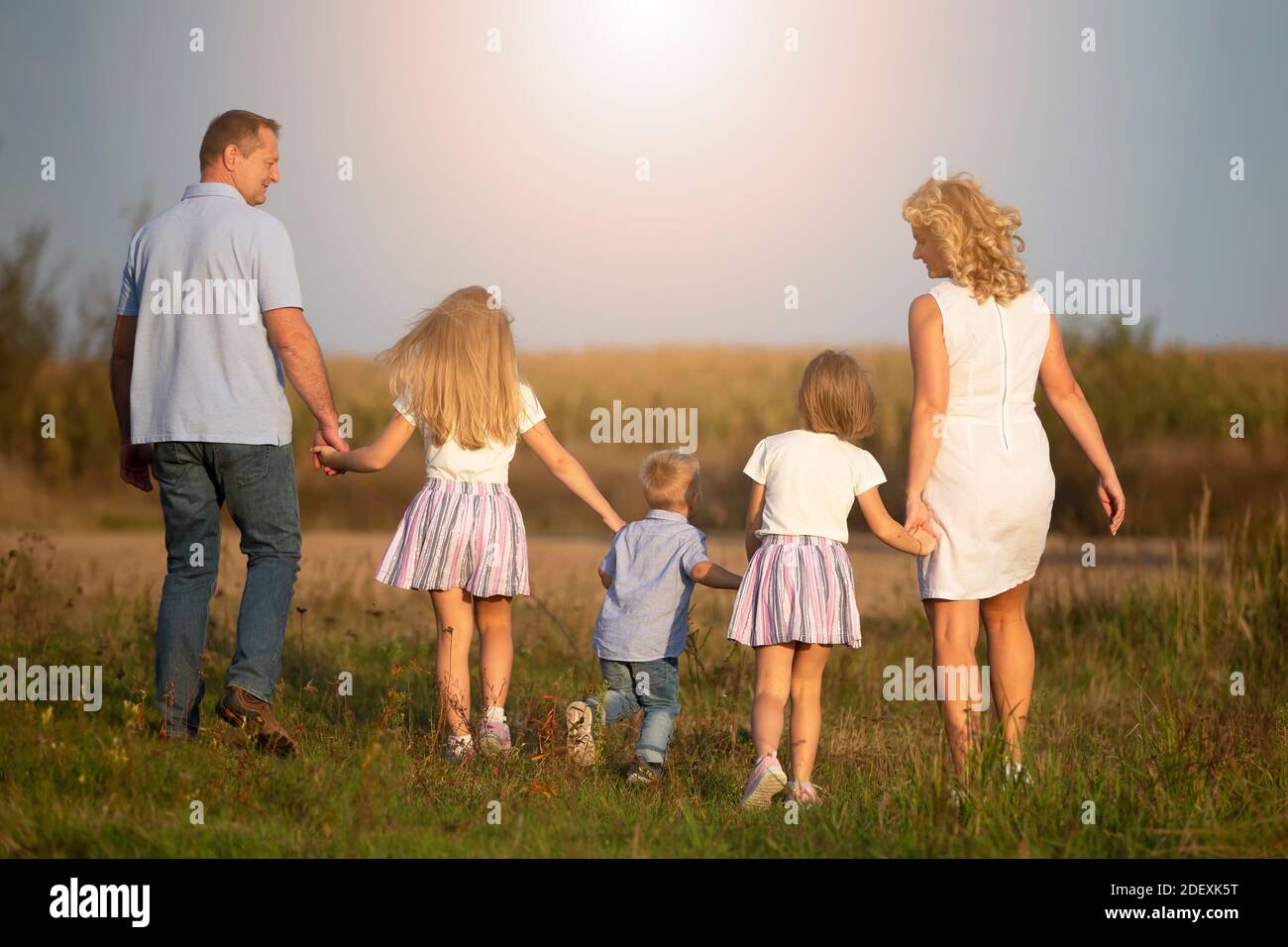 Happy family: mother, father, children, son and daughters in nature at ...