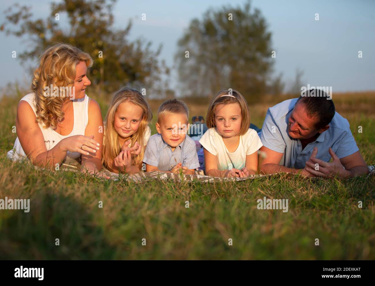 Happy family: mother, father, children, son and daughters in nature. A ...