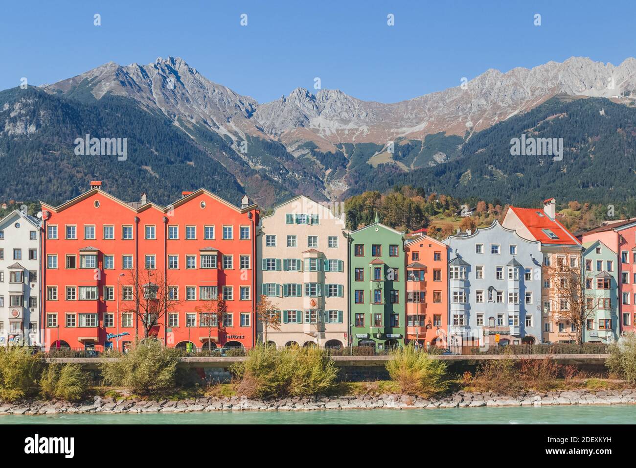 Sunny blue skies and colourful buildings in the Austrian Alps town of ...
