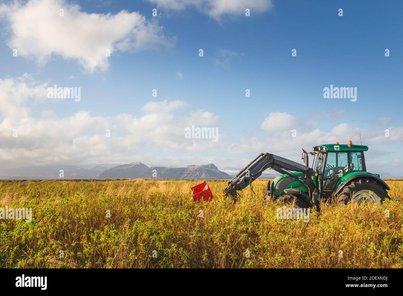 A tractor sits in an open field in Southern Iceland Stock Photo - Alamy