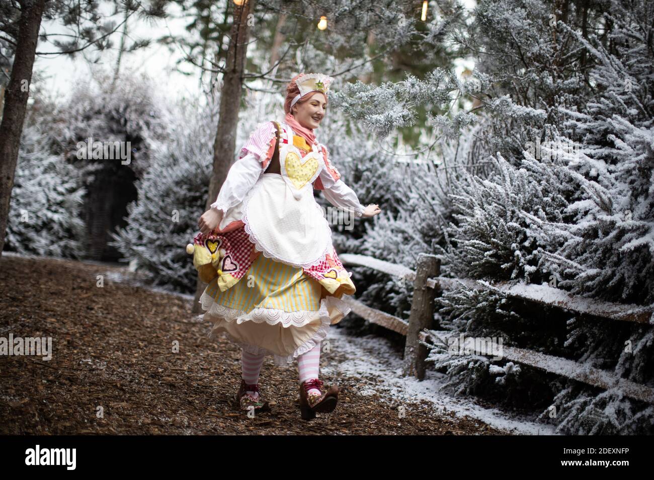 an elf walks through a winter-themed environment at Lapland UK in ...