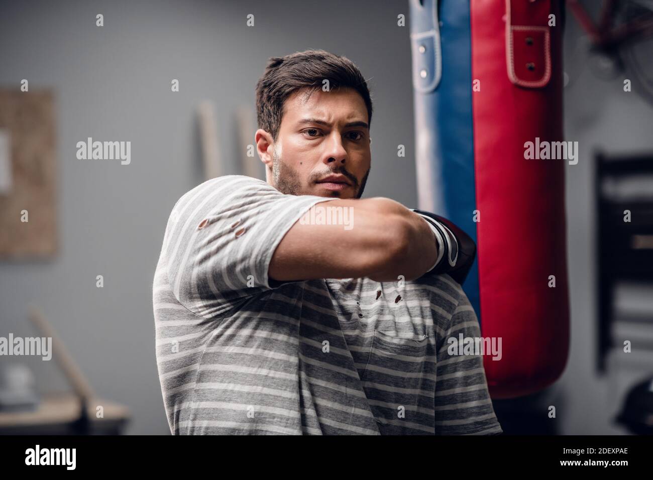 an experienced sportsman is tired after an active Boxing training ...