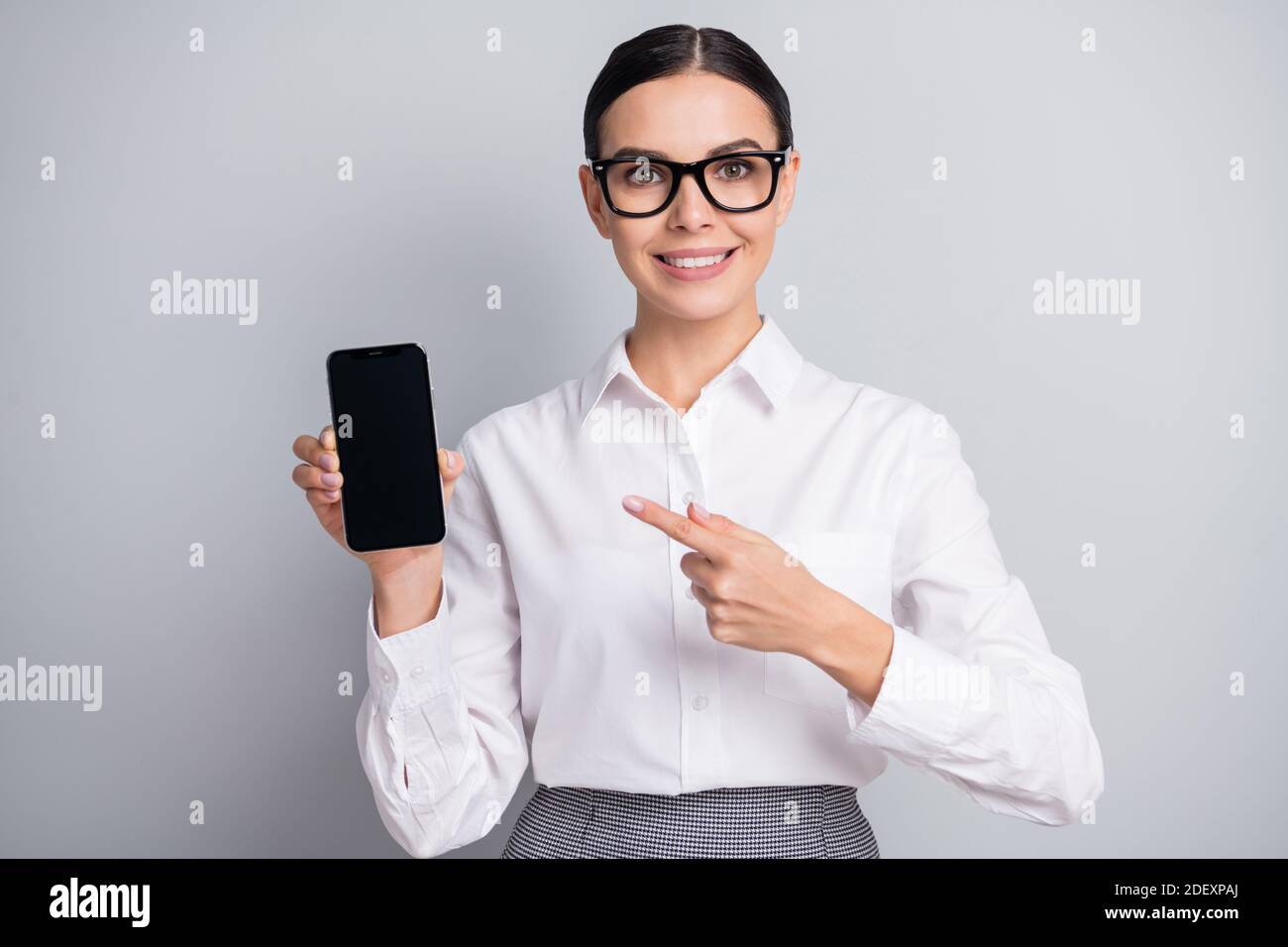 Photo of girl hold phone direct finger screen empty space wear ...