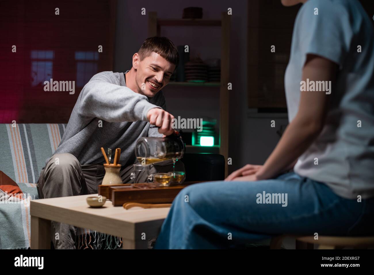 Date in an intimate setting of a tea house. A man and a woman drink ...