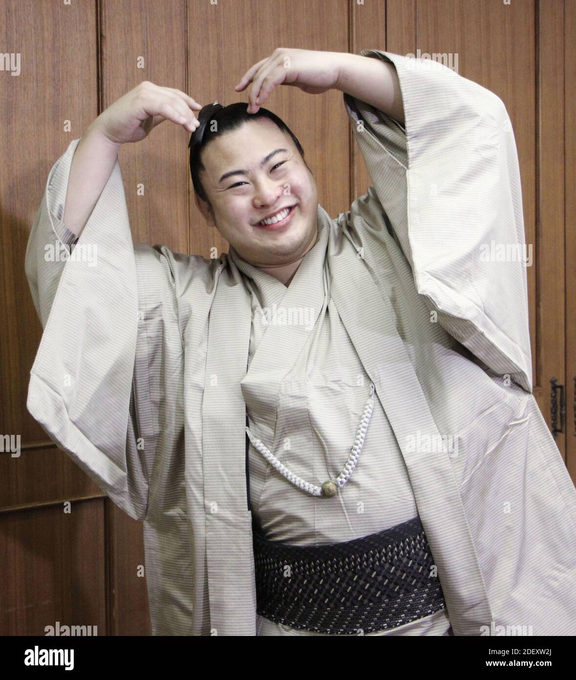 Sumo wrestler Tobizaru poses like a monkey during a visit to the ...