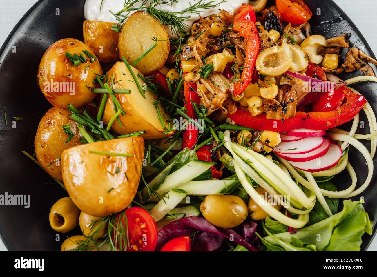 A closeup shot of Mexican meal with fried potatoes, cucumber, tomatoes ...