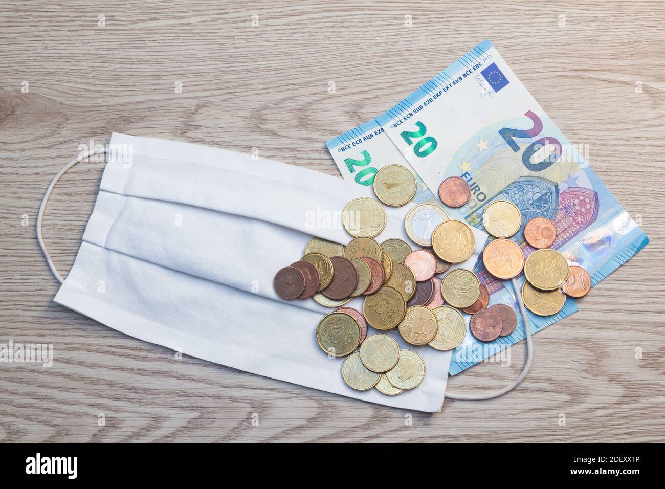 White fabric mask, euros banknotes and coins Stock Photo - Alamy